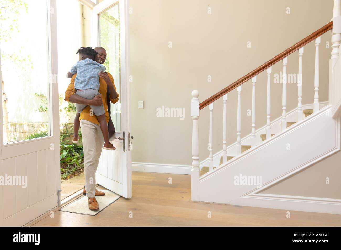 African American man arriving home with his young son Stock Photo - Alamy