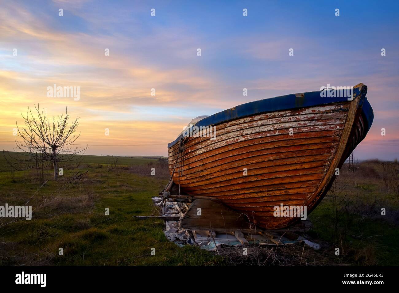 an old boat on an uncultivated field Stock Photo - Alamy