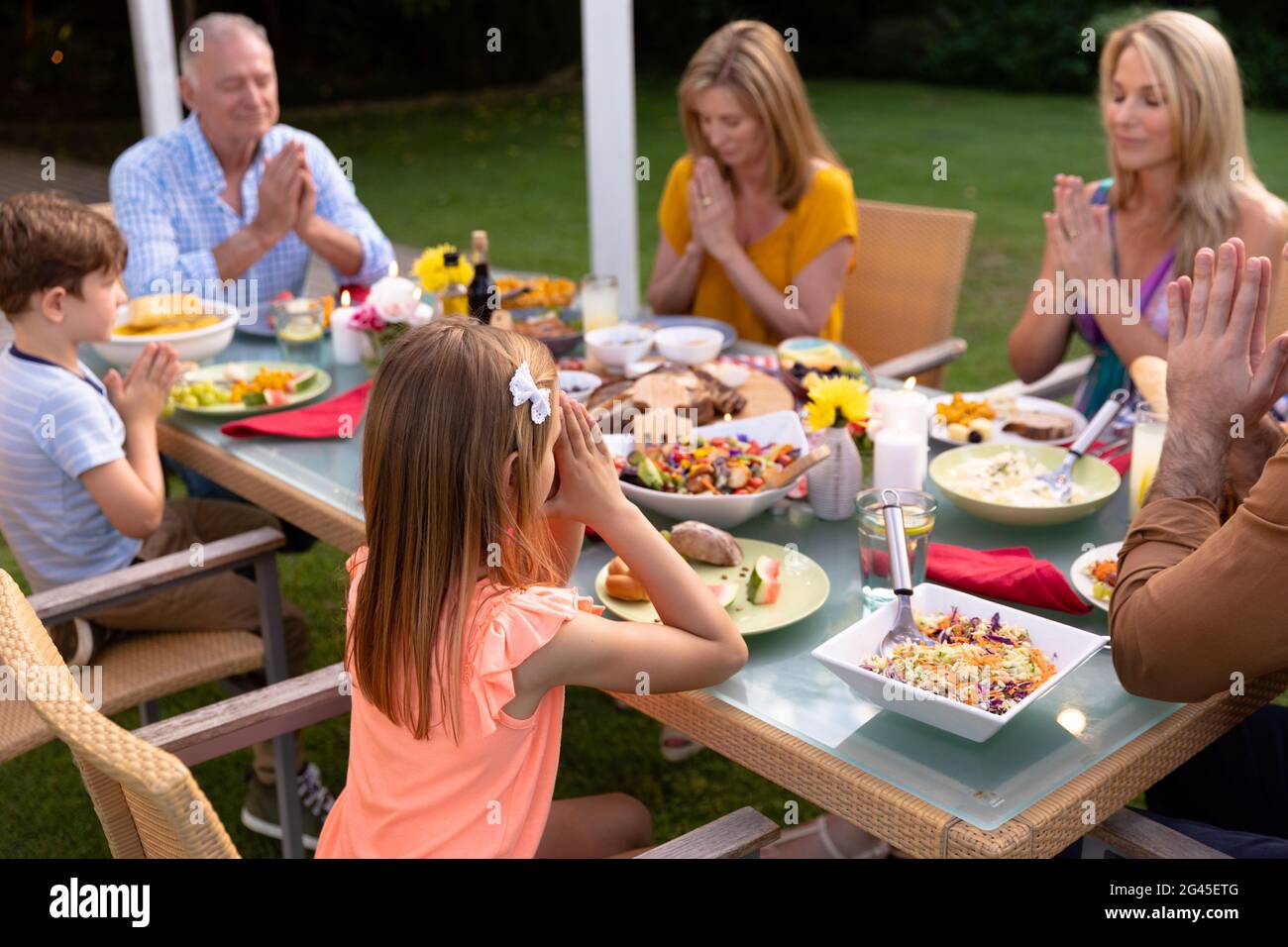 Caucasian family saying grace together before eating Stock Photo - Alamy
