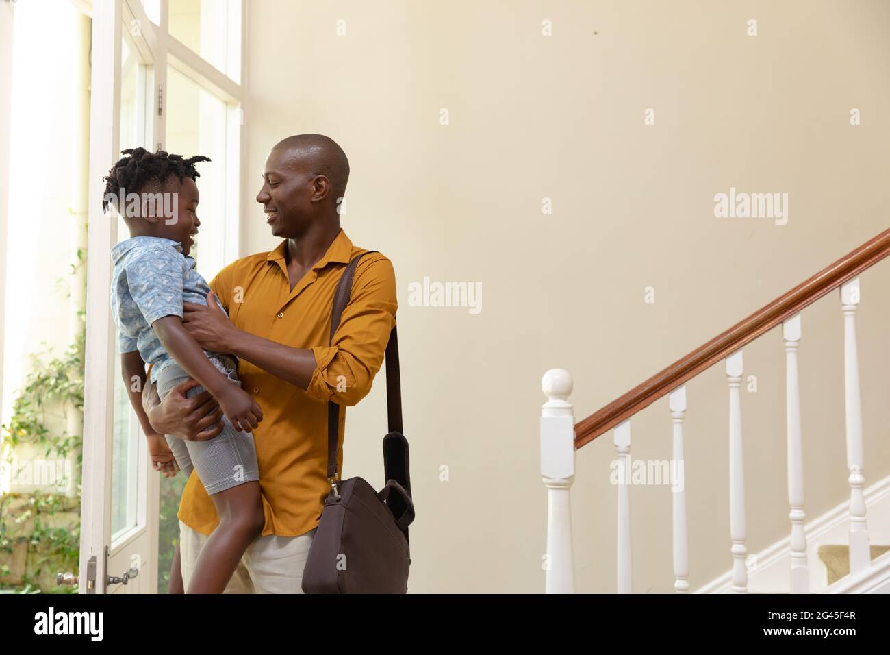 African American man arriving home with his young son Stock Photo - Alamy