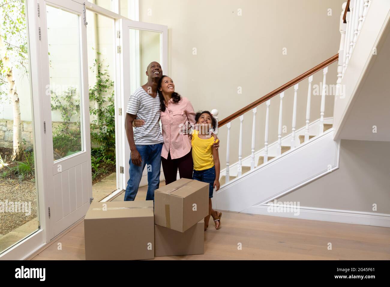 Couple and their daughter arriving in their new home Stock Photo - Alamy