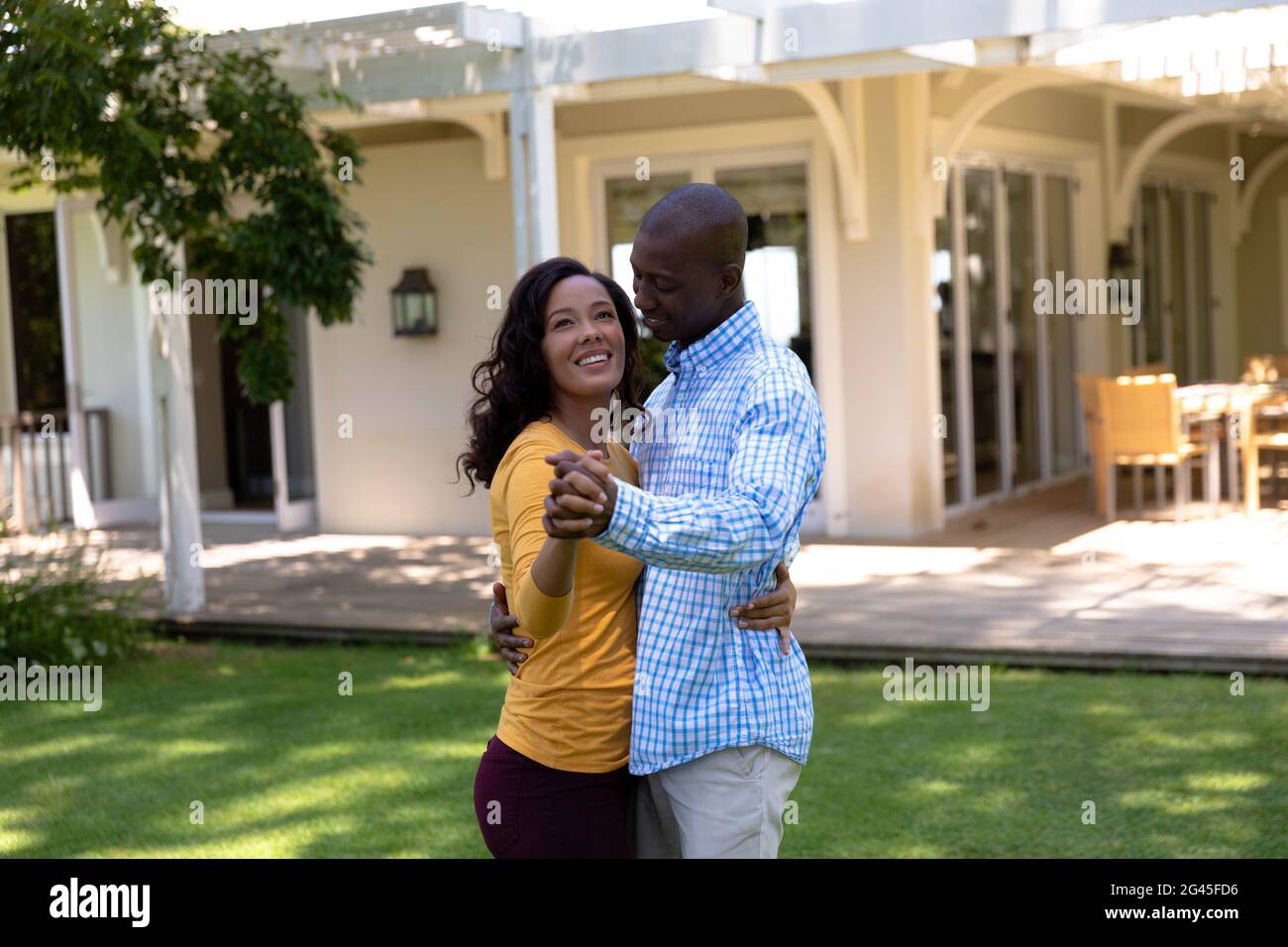 Happy couple dancing in the garden Stock Photo - Alamy
