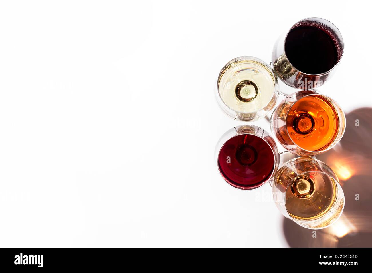 Red, rose and white wine in glasses on white background, top view. Wine ...