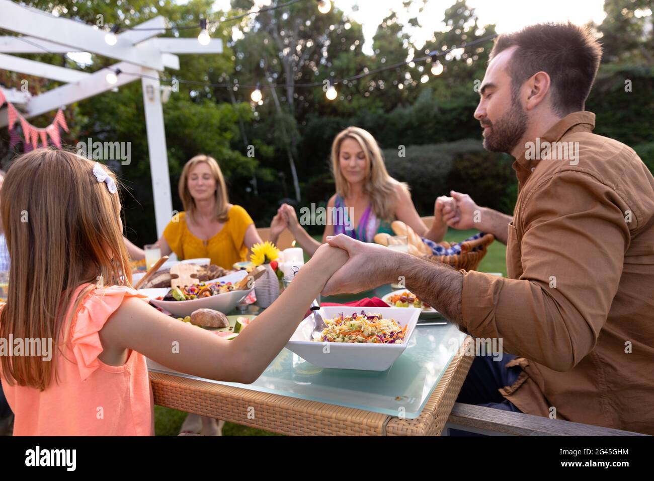 Caucasian family saying grace together before eating Stock Photo - Alamy