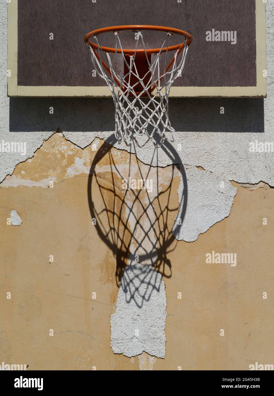 A basketball hoop and its shadow left on the wall Stock Photo - Alamy
