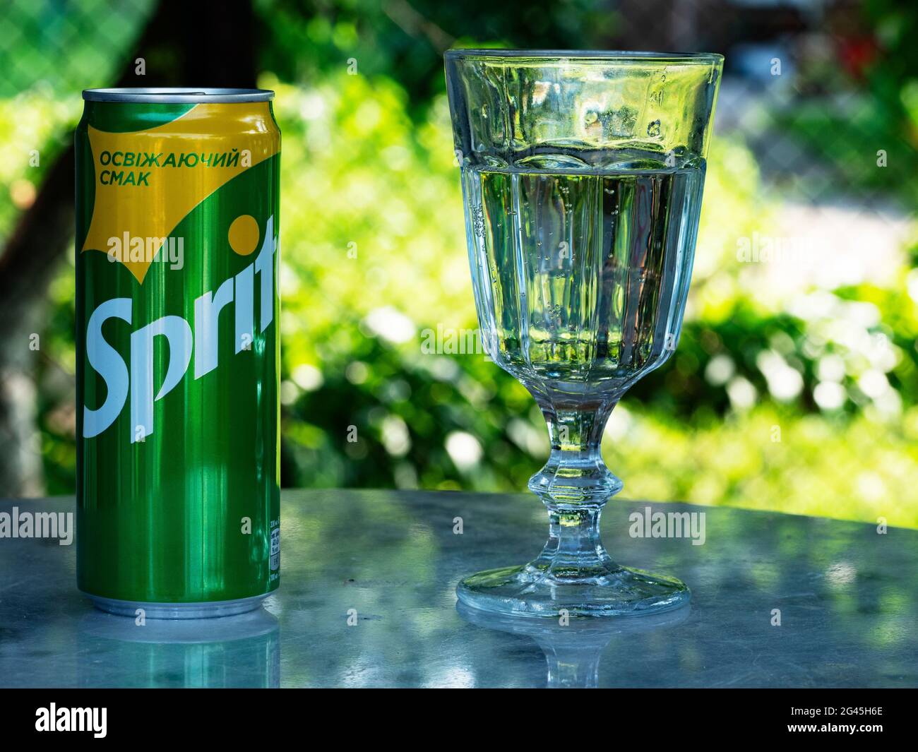 In this photo illustration can and glass of Sprite on a marble table in ...