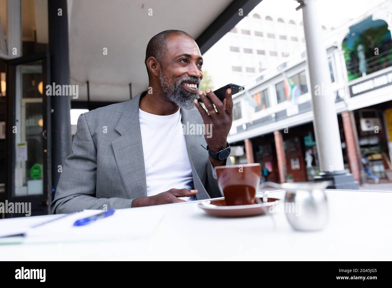 African American man having a phone call at coffee terrace Stock Photo ...
