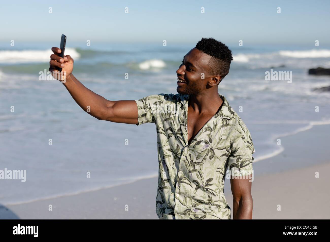 African american man taking a selfie on the beach Stock Photo - Alamy