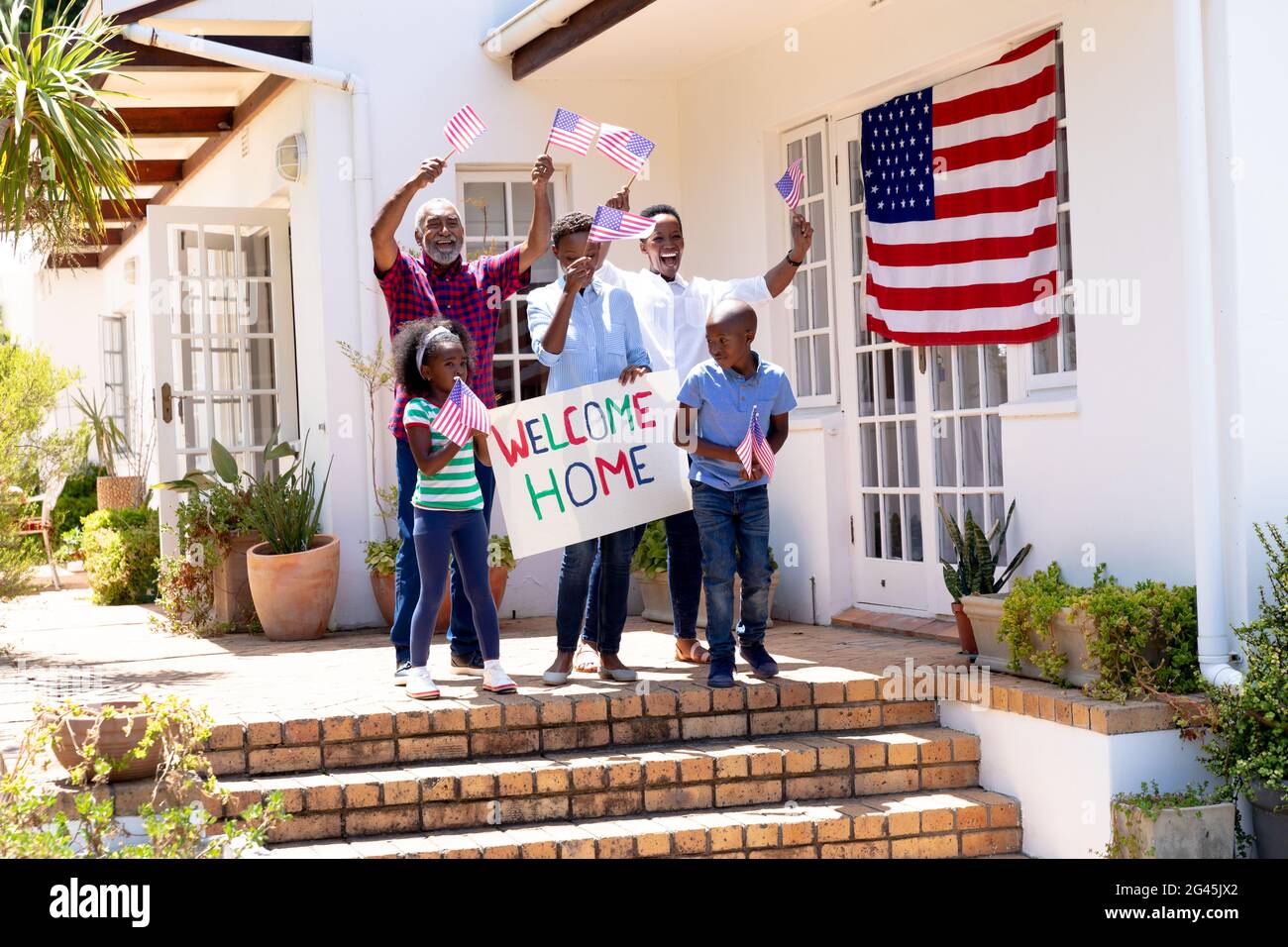 African American three generation family welcoming a soldier coming ...