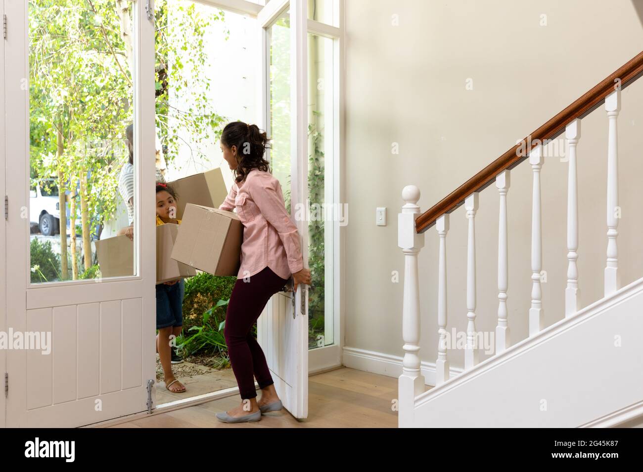Couple and their daughter arriving in their new home Stock Photo - Alamy