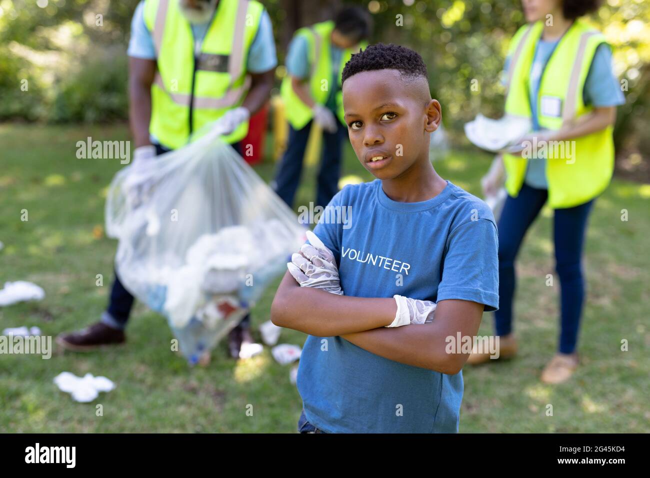 Portrait of a mixed race boy collecting garbage Stock Photo - Alamy