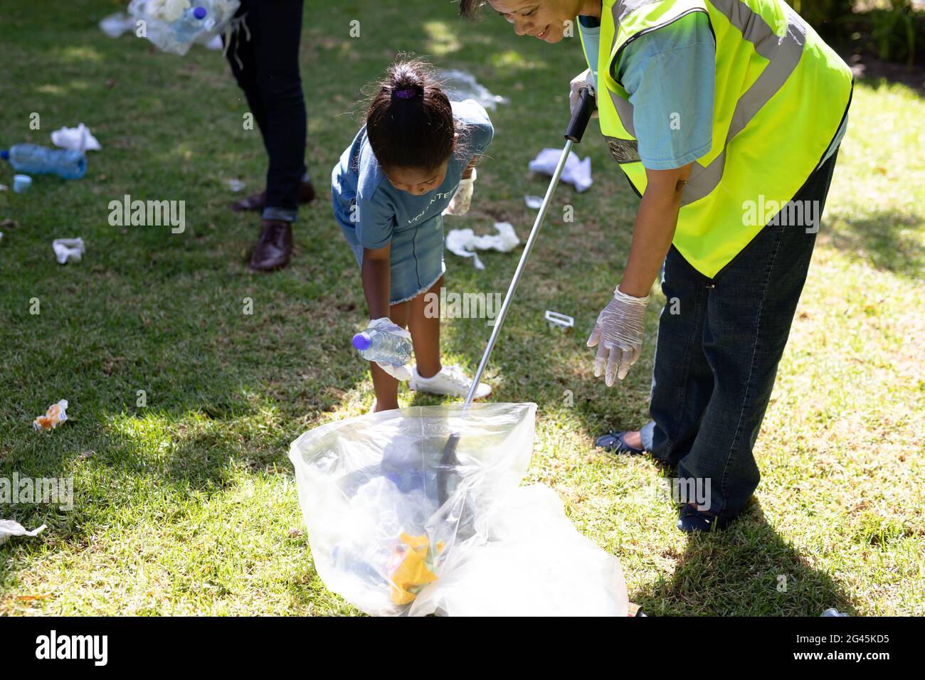 Multi-generation mixed race family collecting garbage Stock Photo - Alamy