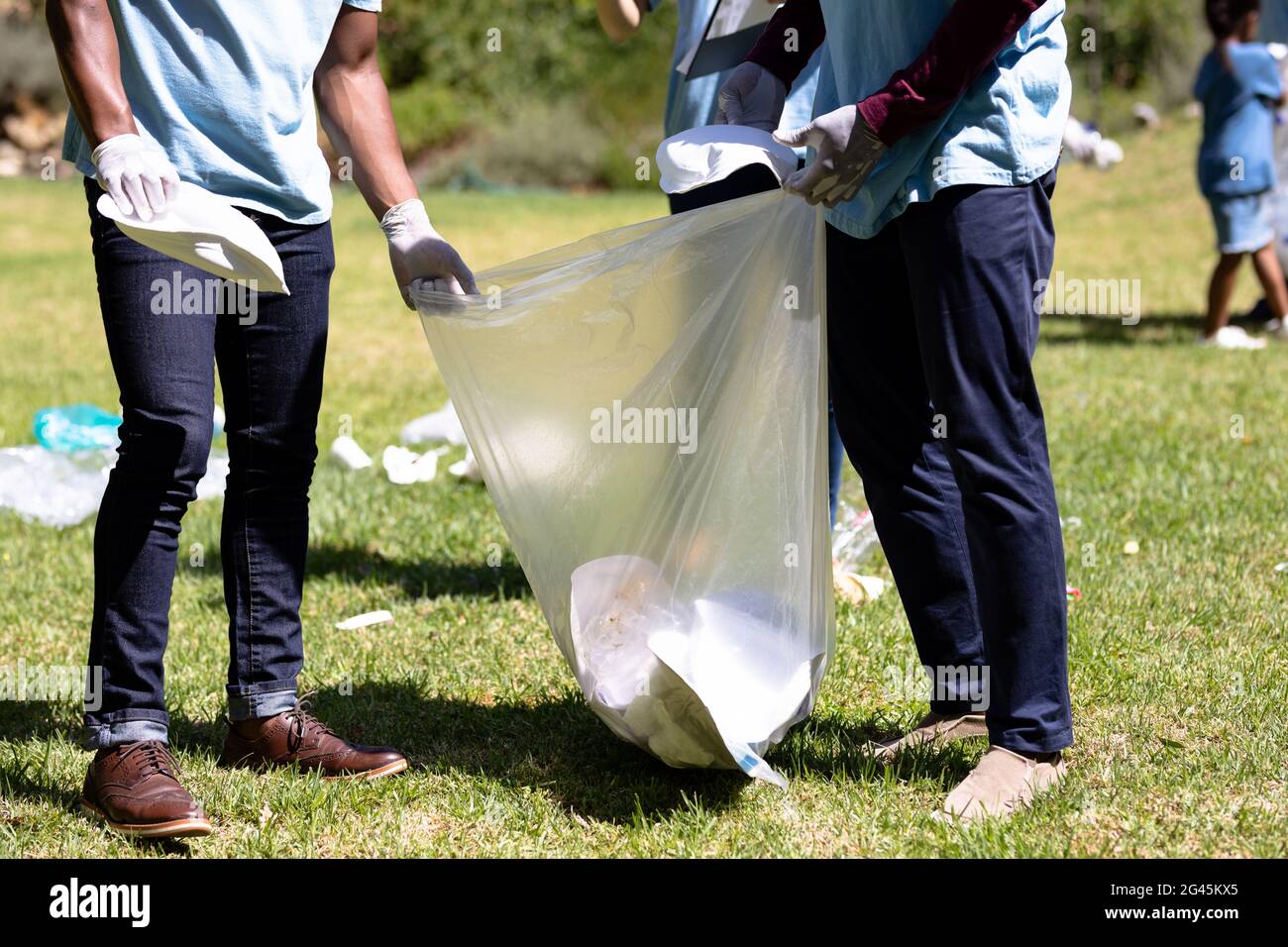 People collecting garbage together Stock Photo - Alamy