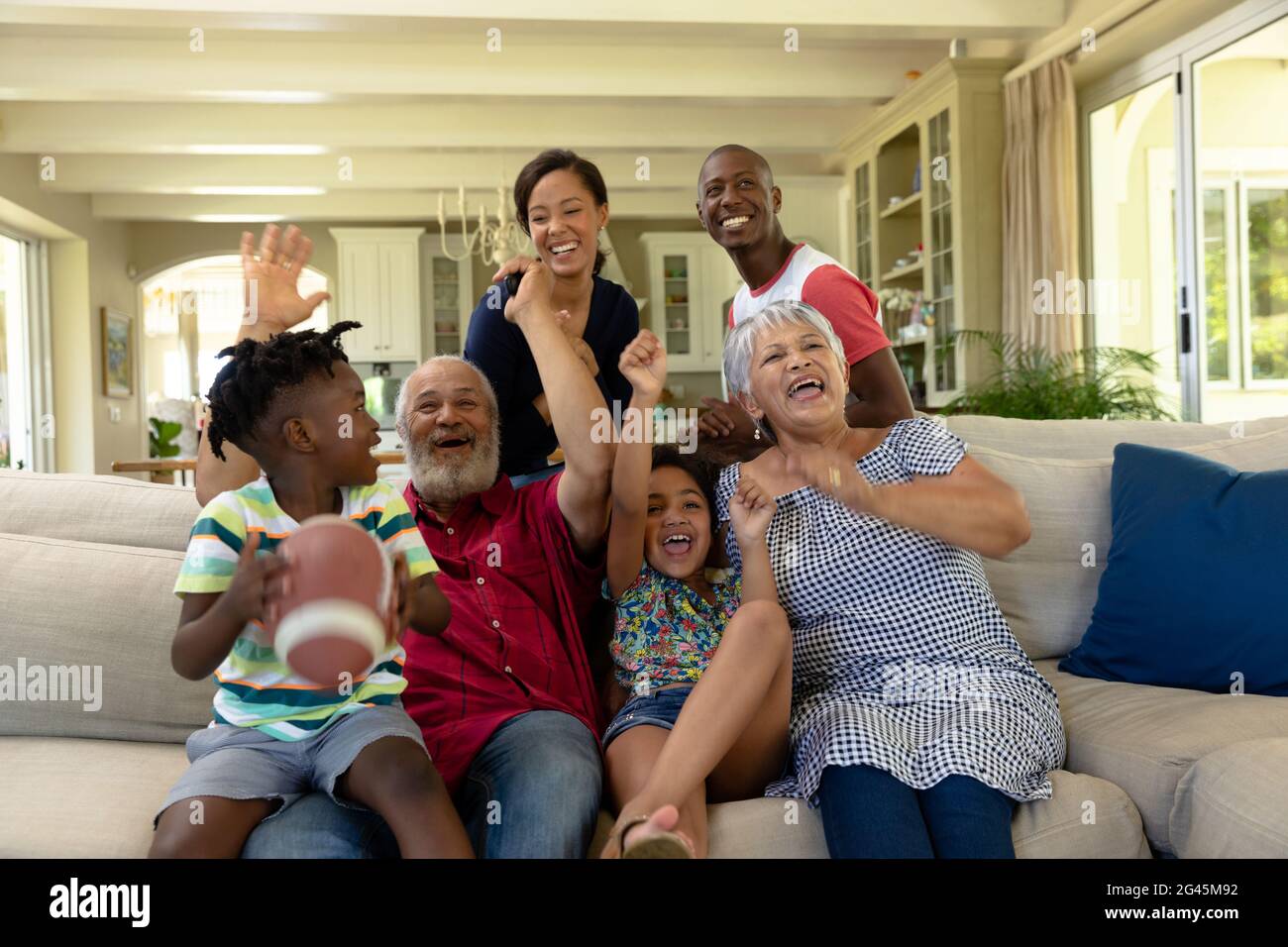Multi-generation mixed race family at home Stock Photo - Alamy