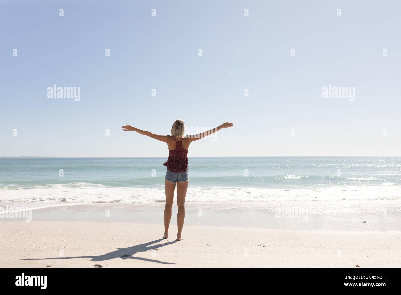 Raising arms beach woman hi-res stock photography and images - Alamy