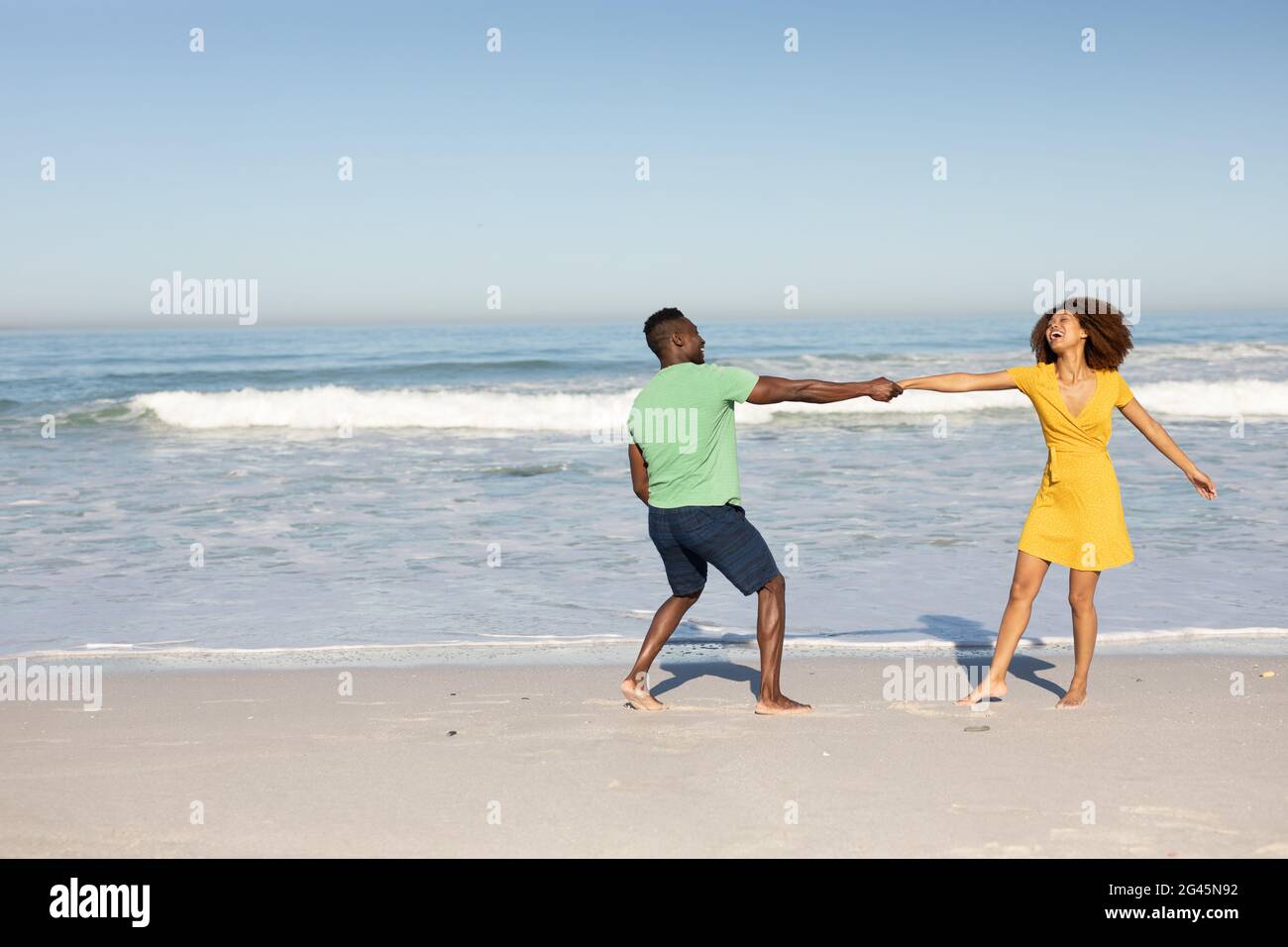 Mixed race couple dancing on the beach Stock Photo - Alamy