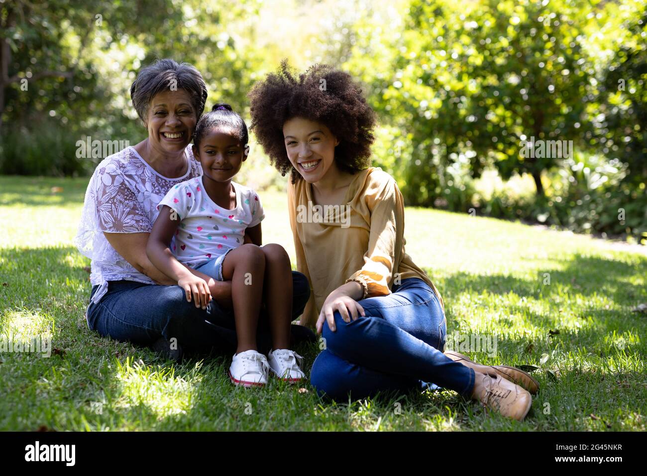 Multi-generation mixed race family enjoying their time at a garden ...