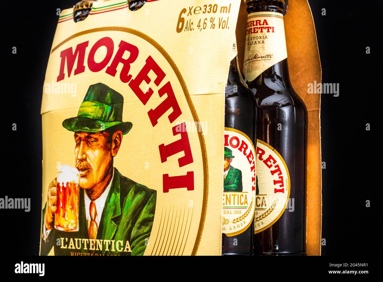 6 pack of Birra Moretti beer on wooden barrel with dark background ...