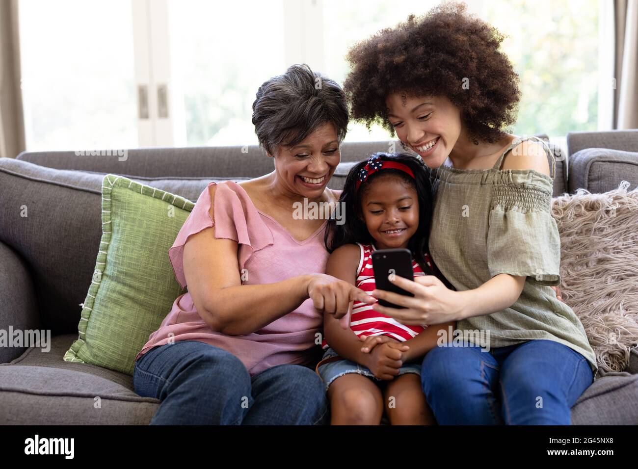 Multi-generation mixed-race family enjoying their time at home Stock ...