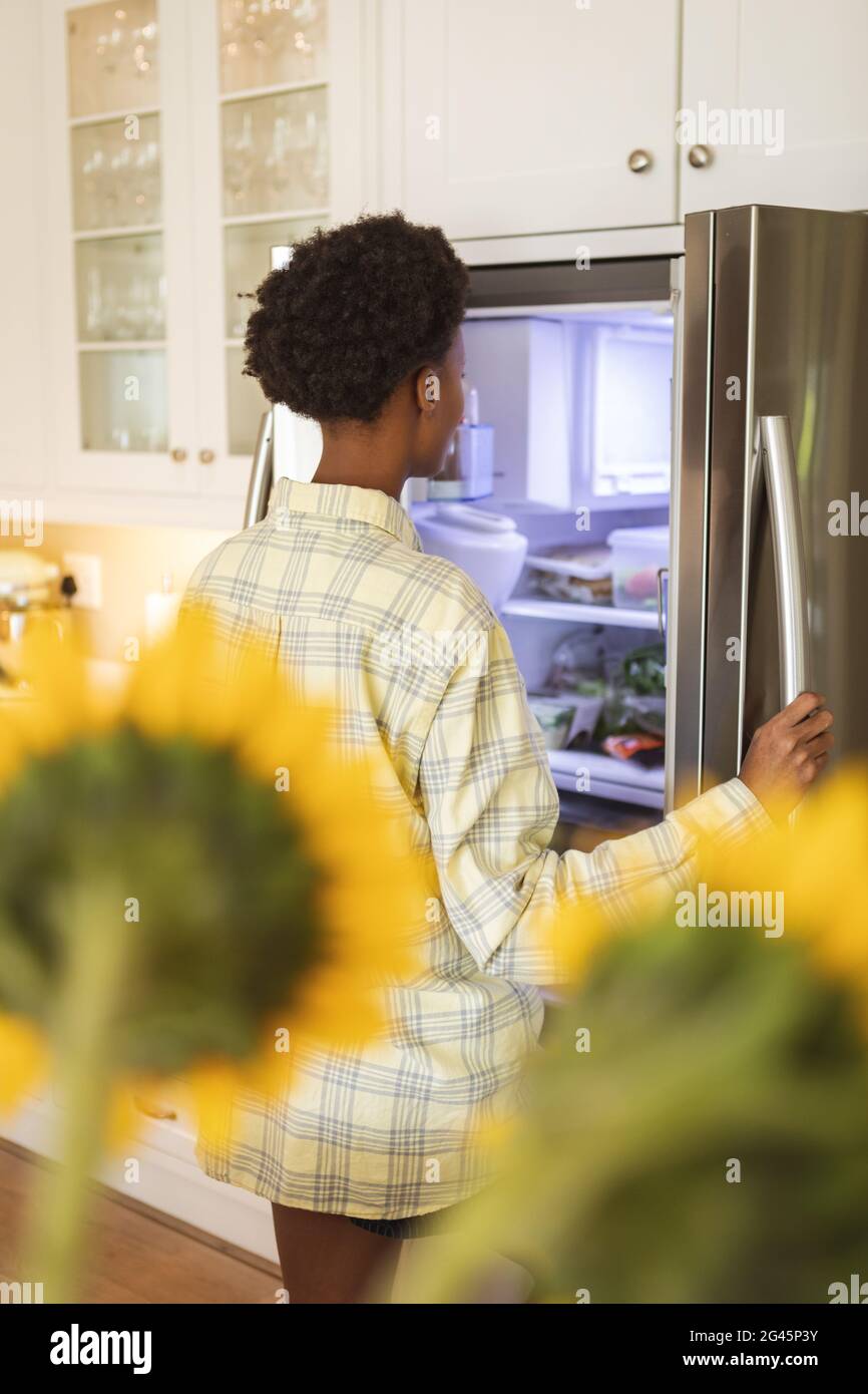 Woman opening the fridge Stock Photo - Alamy