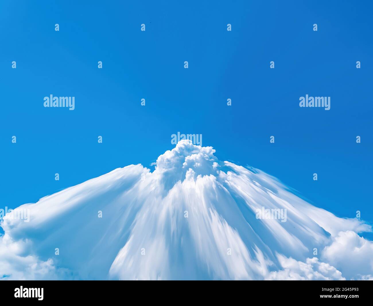 Abstract illustration of a cloudy volcano erupting in the blue sky ...