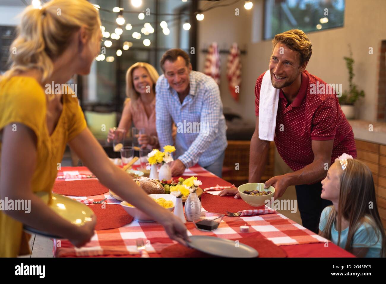 Multi-generation Caucasian family setting a table Stock Photo - Alamy