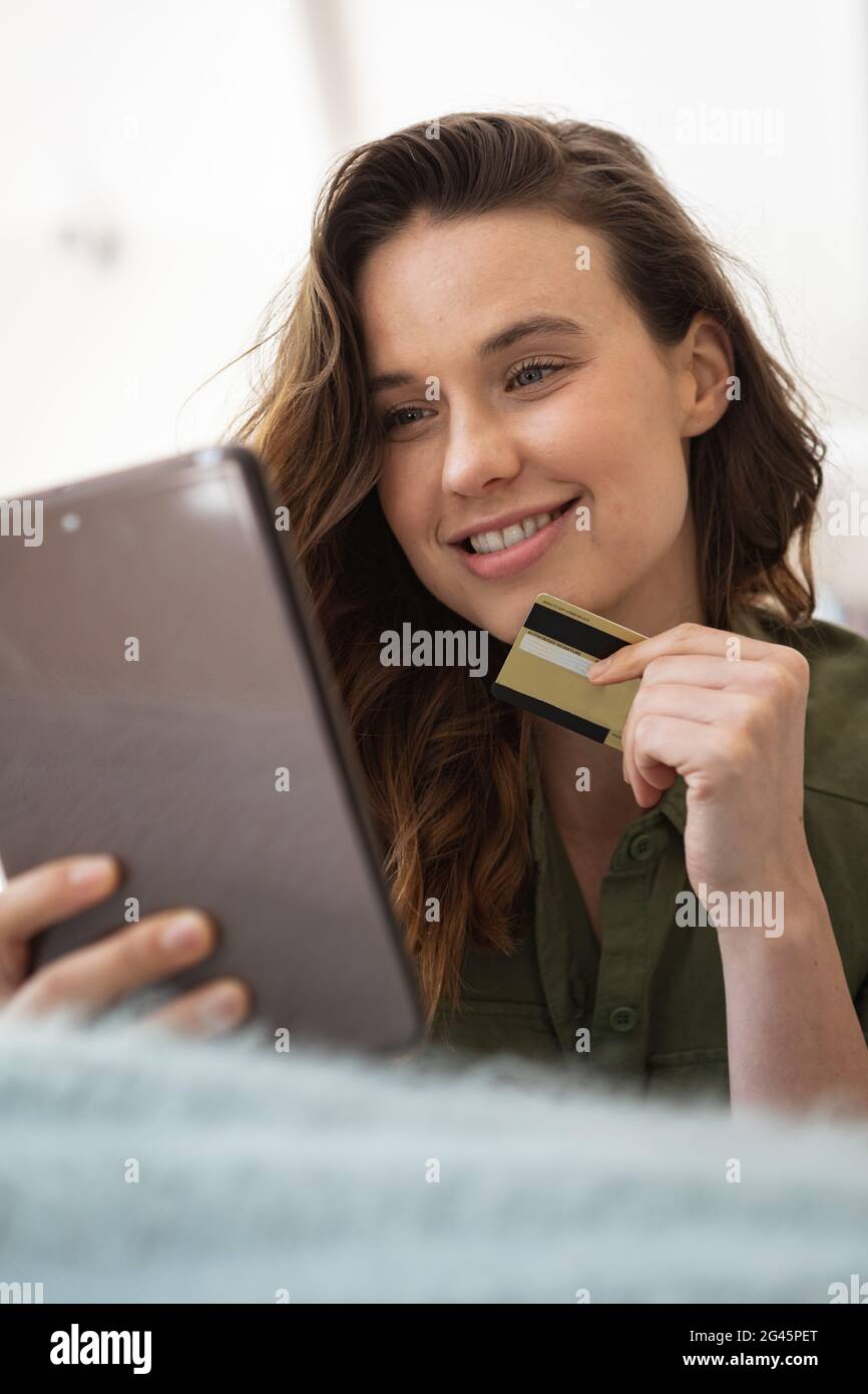 Woman with credit card using digital tablet at home Stock Photo - Alamy