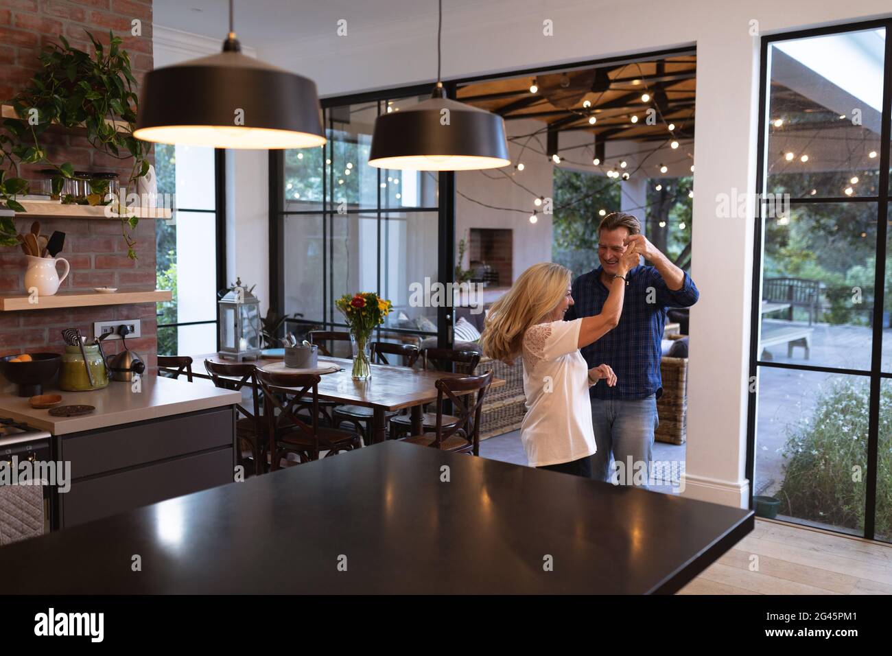 Senior Caucasian couple dancing at home during coronavirus covid19 ...