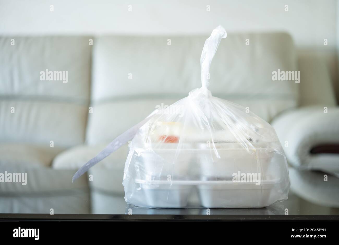 food delivery pack in a living room in front of a sofa Stock Photo - Alamy