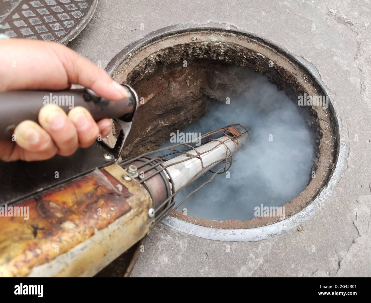spraying disinfectant to the sewer Stock Photo - Alamy