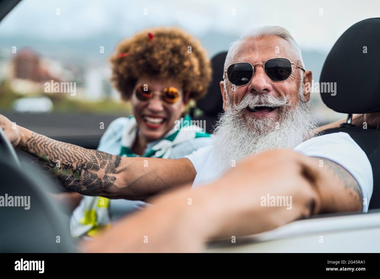 Happy senior couple having fun driving on new convertible car - Mature ...