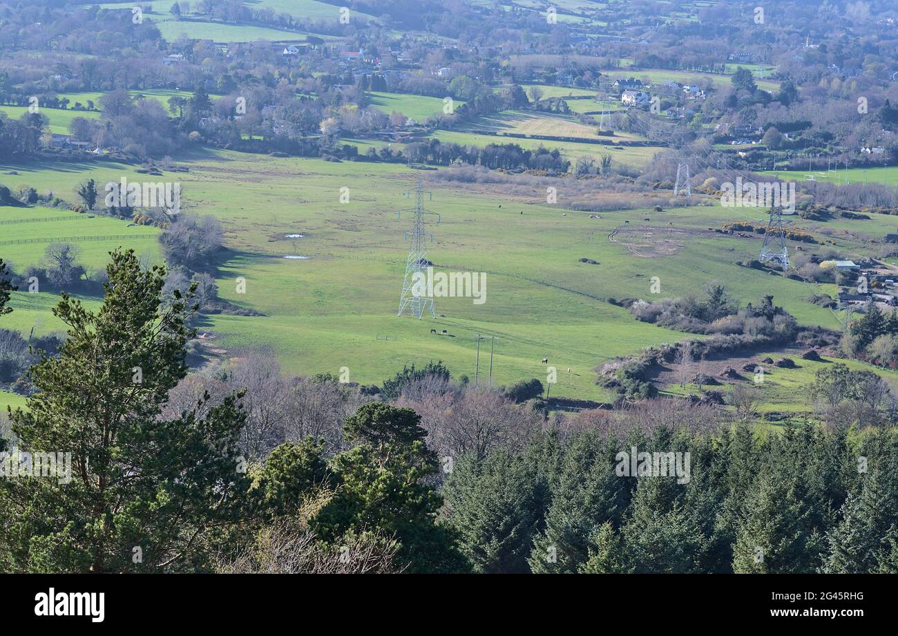 Beautiful bright aerial-like view of green fields, and high voltage ...