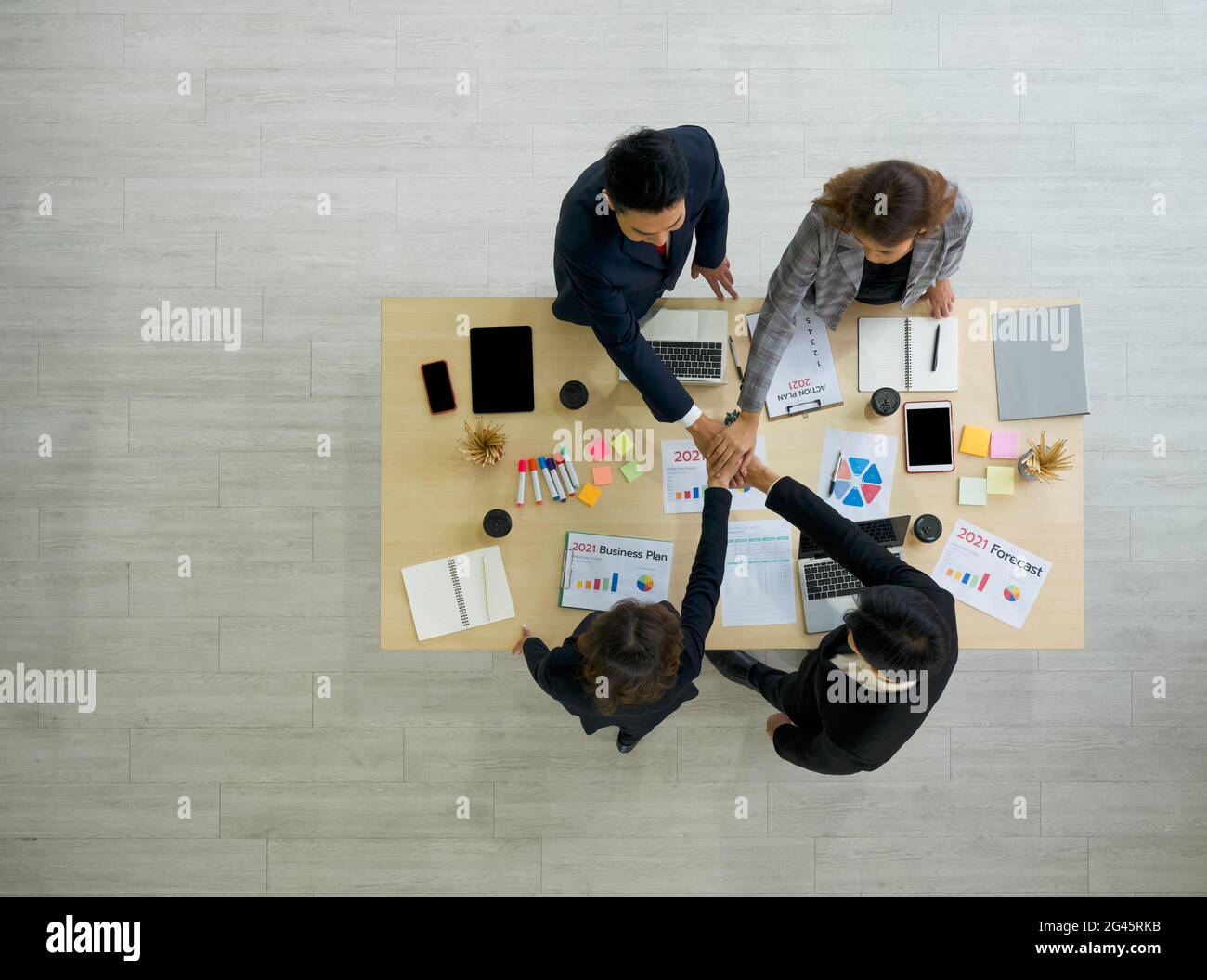 Business partners join hands in the modern office. Business executives ...