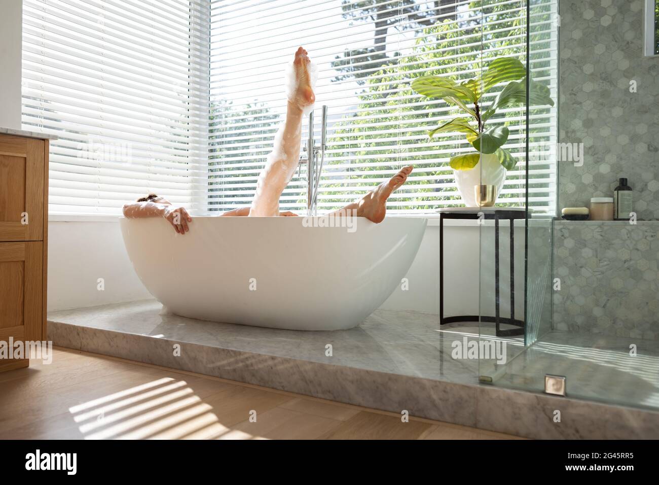 Woman relaxing in a bathtub Stock Photo - Alamy