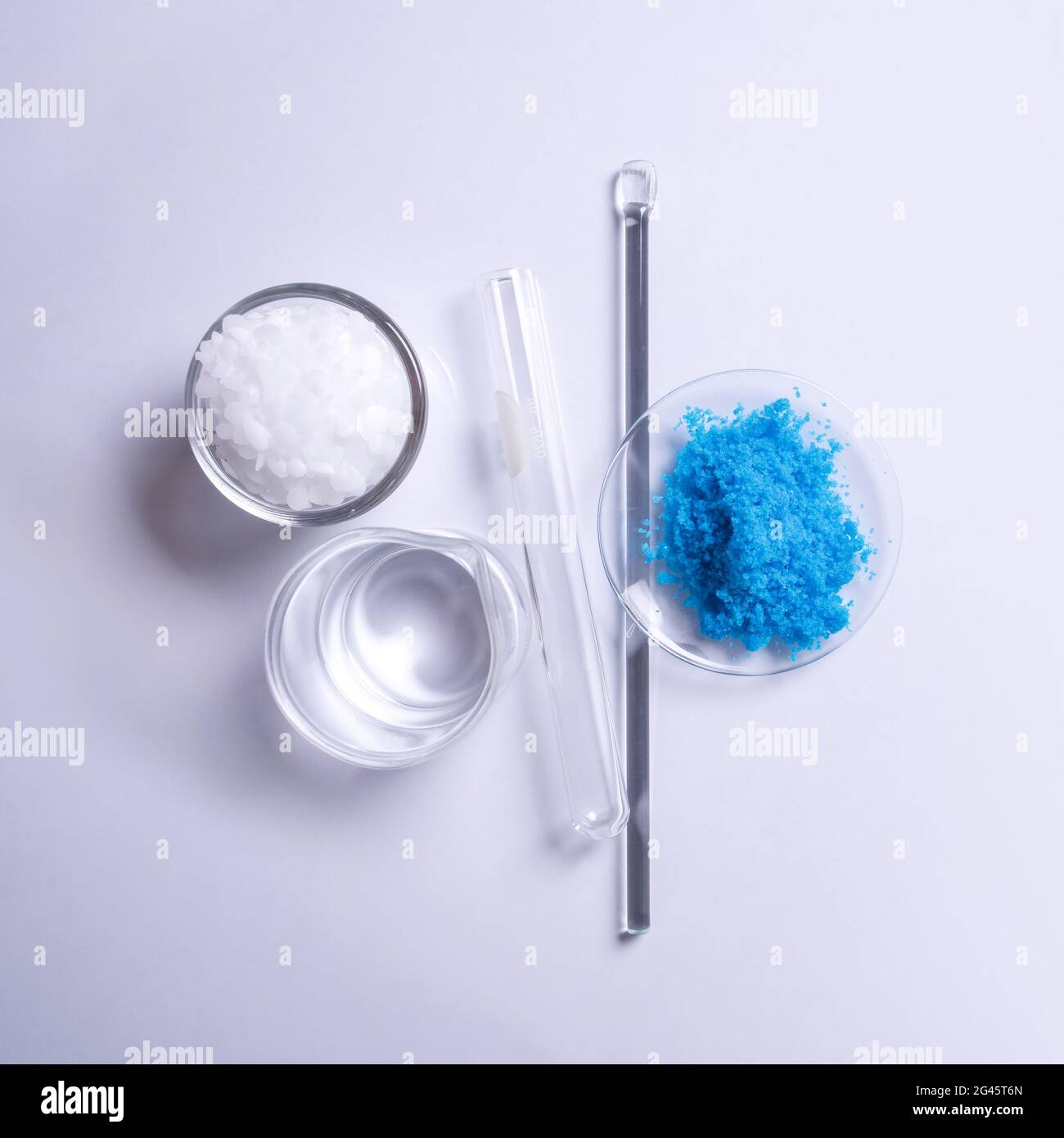 Microcrystalline wax in glass container, Crystal clear liquid in beaker ...