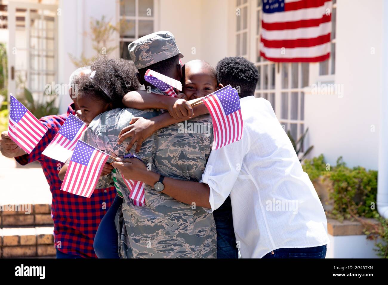 African American male soldier wearing uniform and his family standing ...