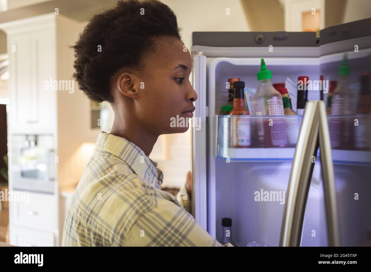 Woman opening the fridge Stock Photo - Alamy