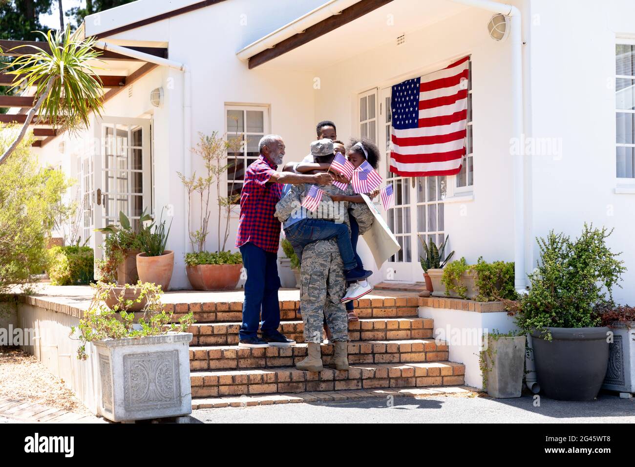 African American male soldier wearing uniform and his family standing ...
