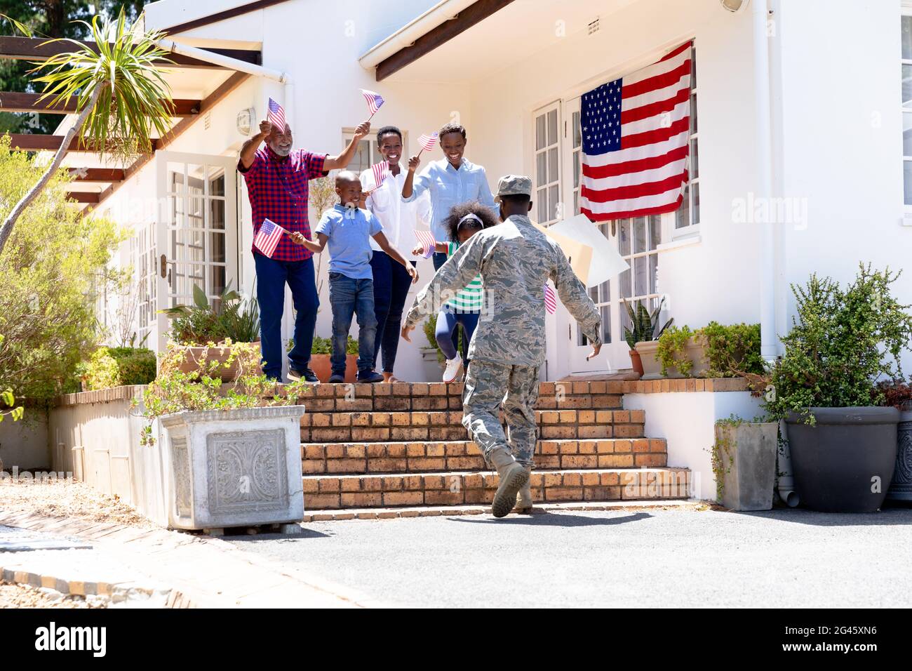 African American male soldier wearing uniform and his family standing ...