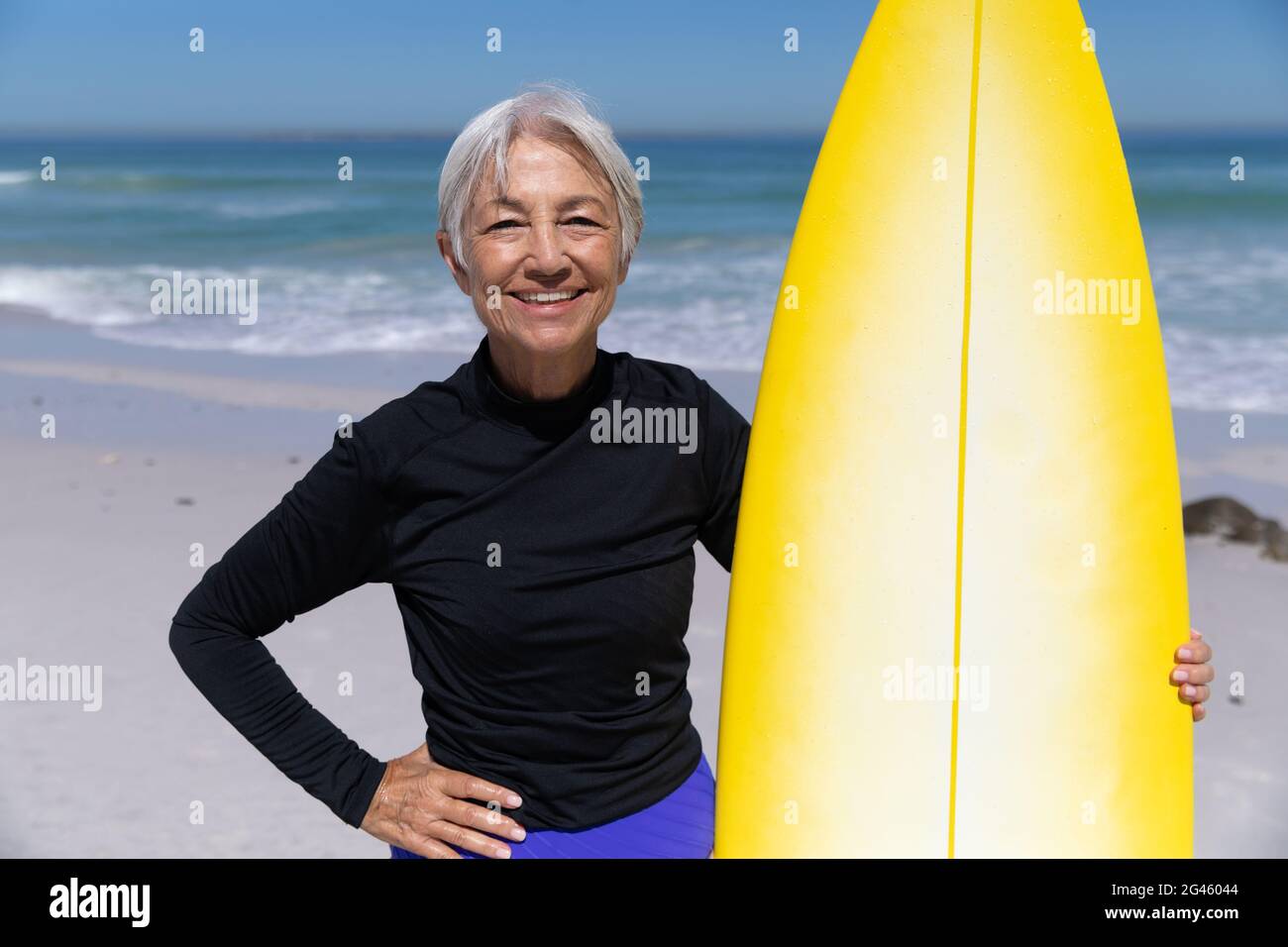 Senior Caucasian woman holding a surfboard at the beach Stock Photo - Alamy