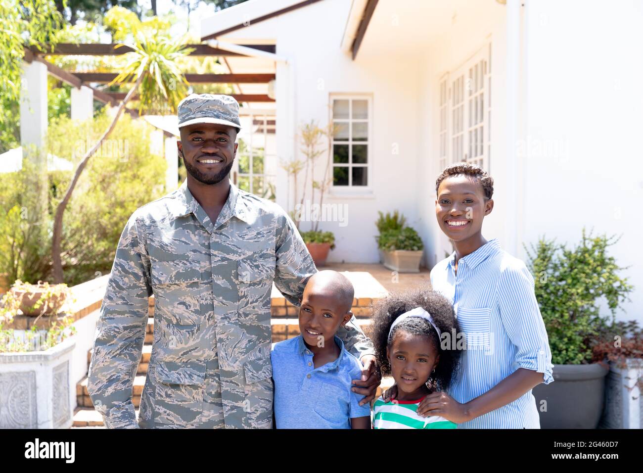 African American male soldier wearing uniform and his family standing ...