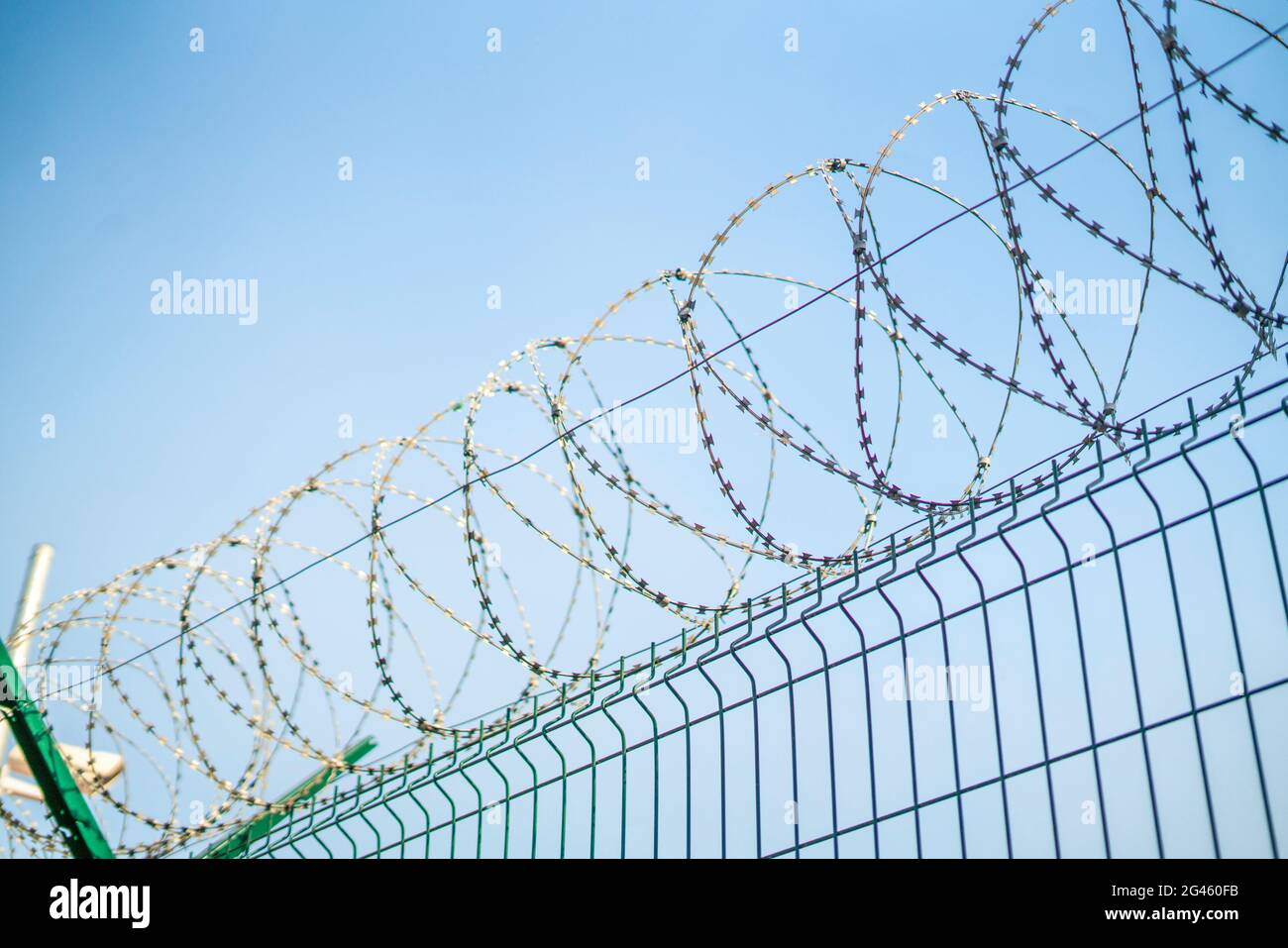 the barbed wire fence of protected prison territory Stock Photo - Alamy