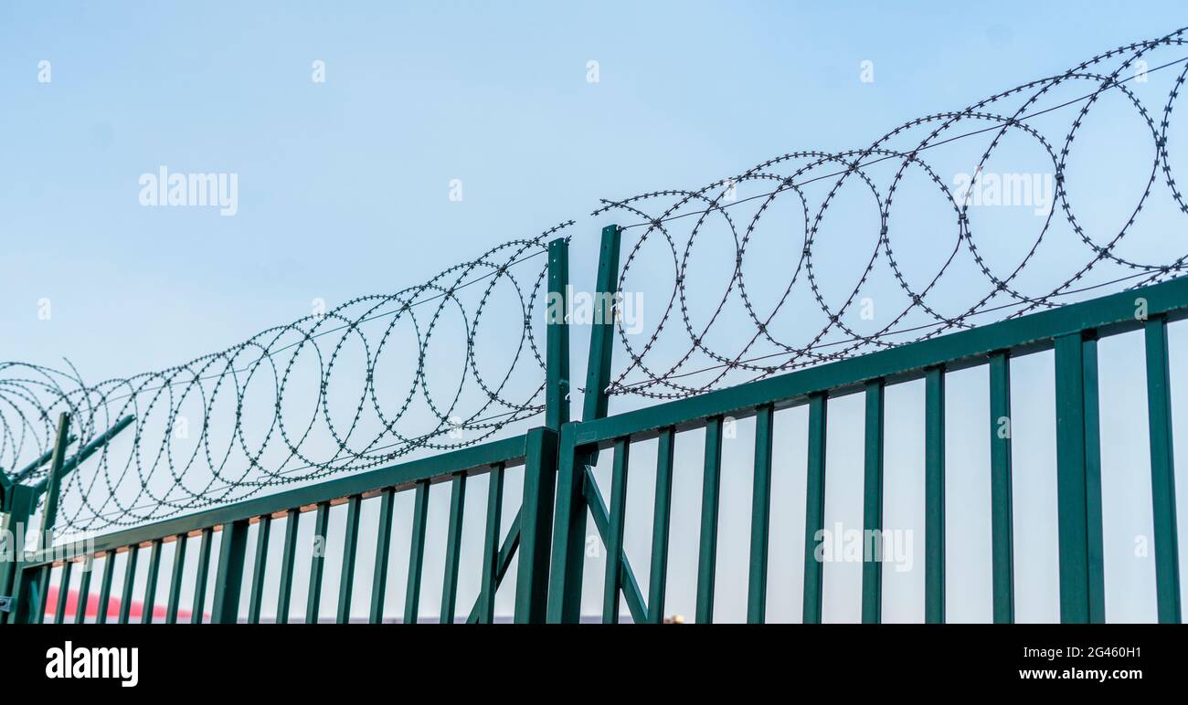 the barbed wire fence of protected prison territory Stock Photo - Alamy