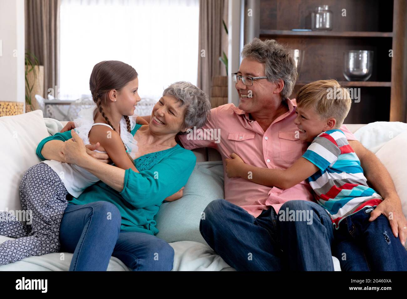 Caucasian girl and boy spending time together with their grandparents ...