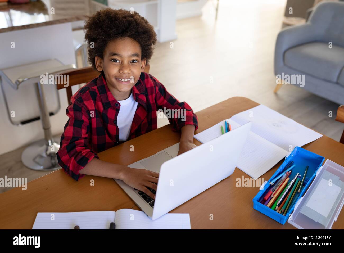 Portrait of boy using laptop at home Stock Photo - Alamy