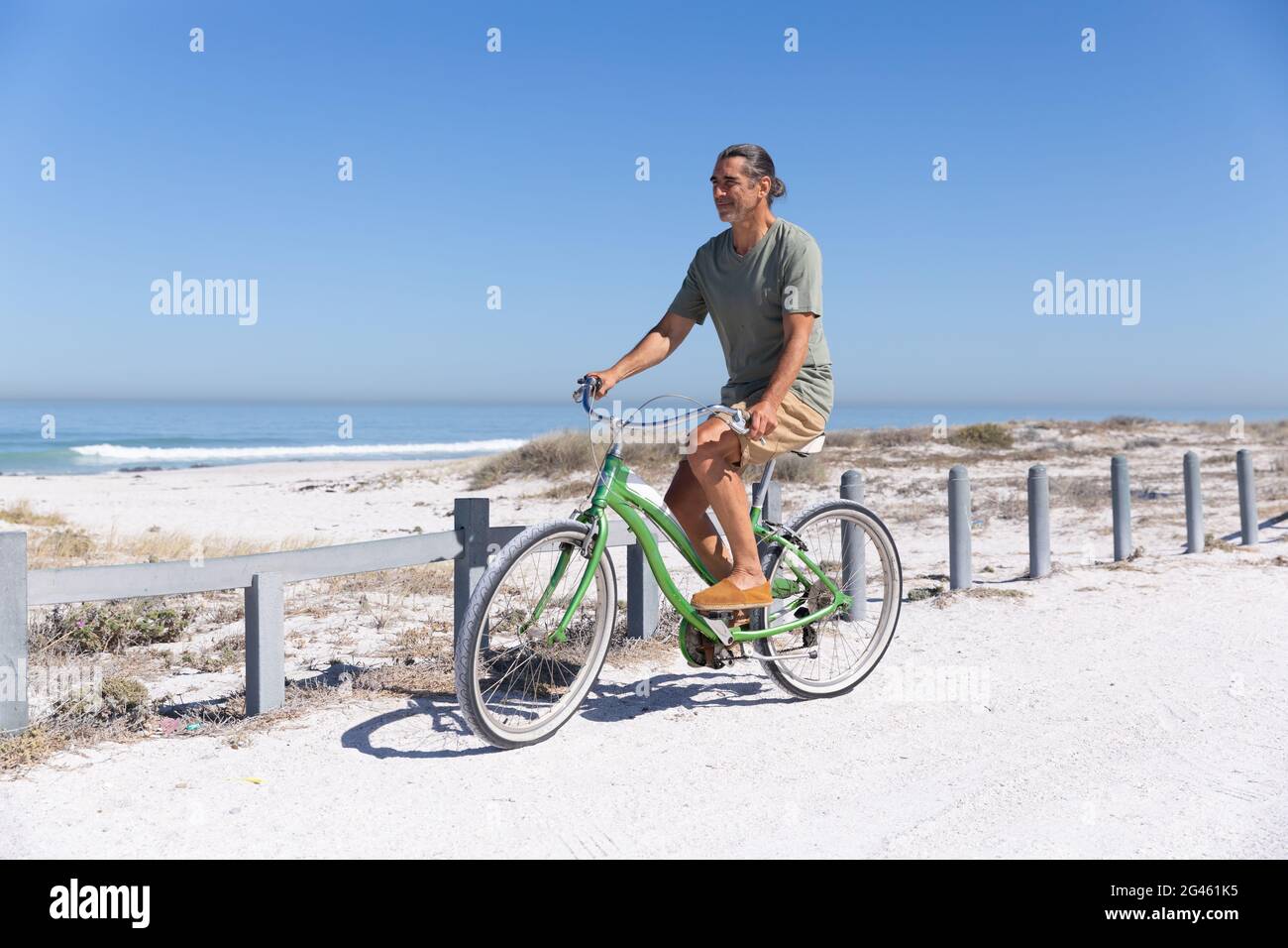 Senior Caucasian man riding a bike at the beach Stock Photo - Alamy