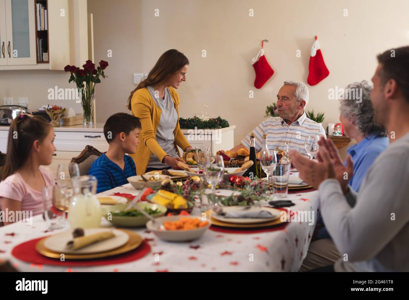 Multi generation caucasian family sitting at table for dinner together ...