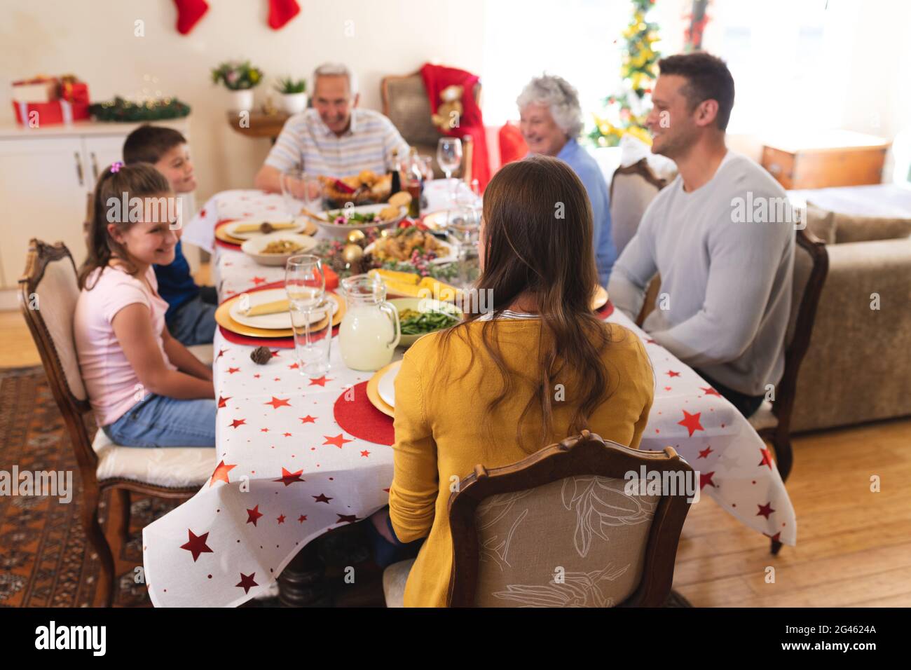 Multi generation caucasian family sitting at table for dinner together ...
