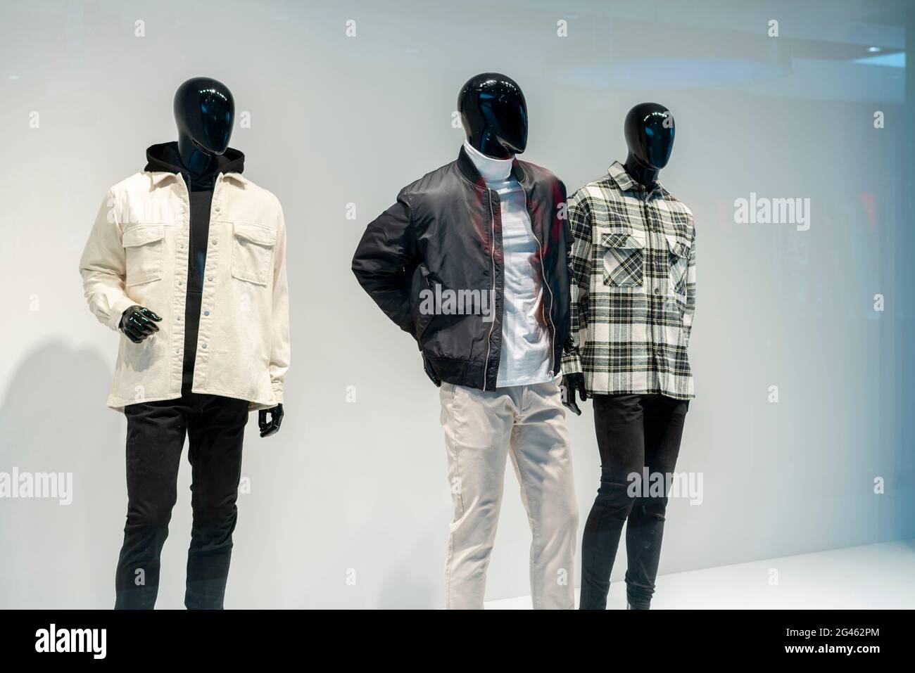 window glass case in the shop with manequins showing new clothes Stock ...