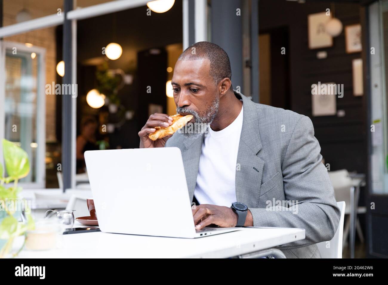 African American man working on his laptop at coffee terrace Stock ...